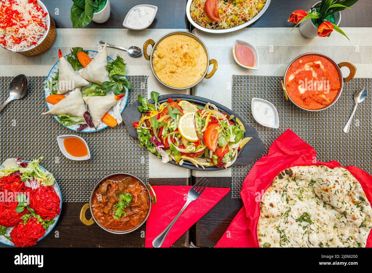 Traditional Indian food with red curry, yellow korma, coconut, forks ...