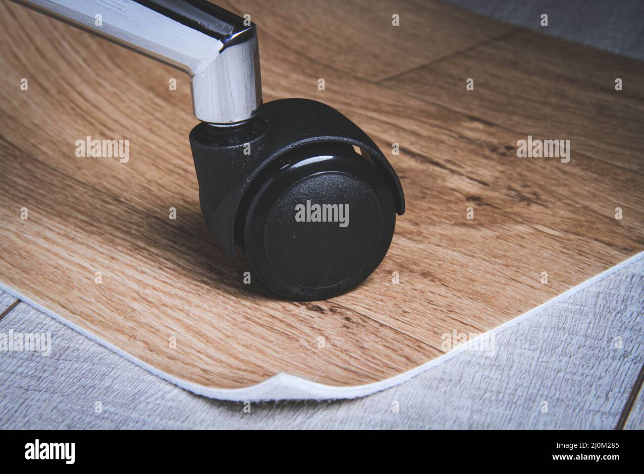 Linoleum in the office. Armchair on wheels on linoleum. Floor ...