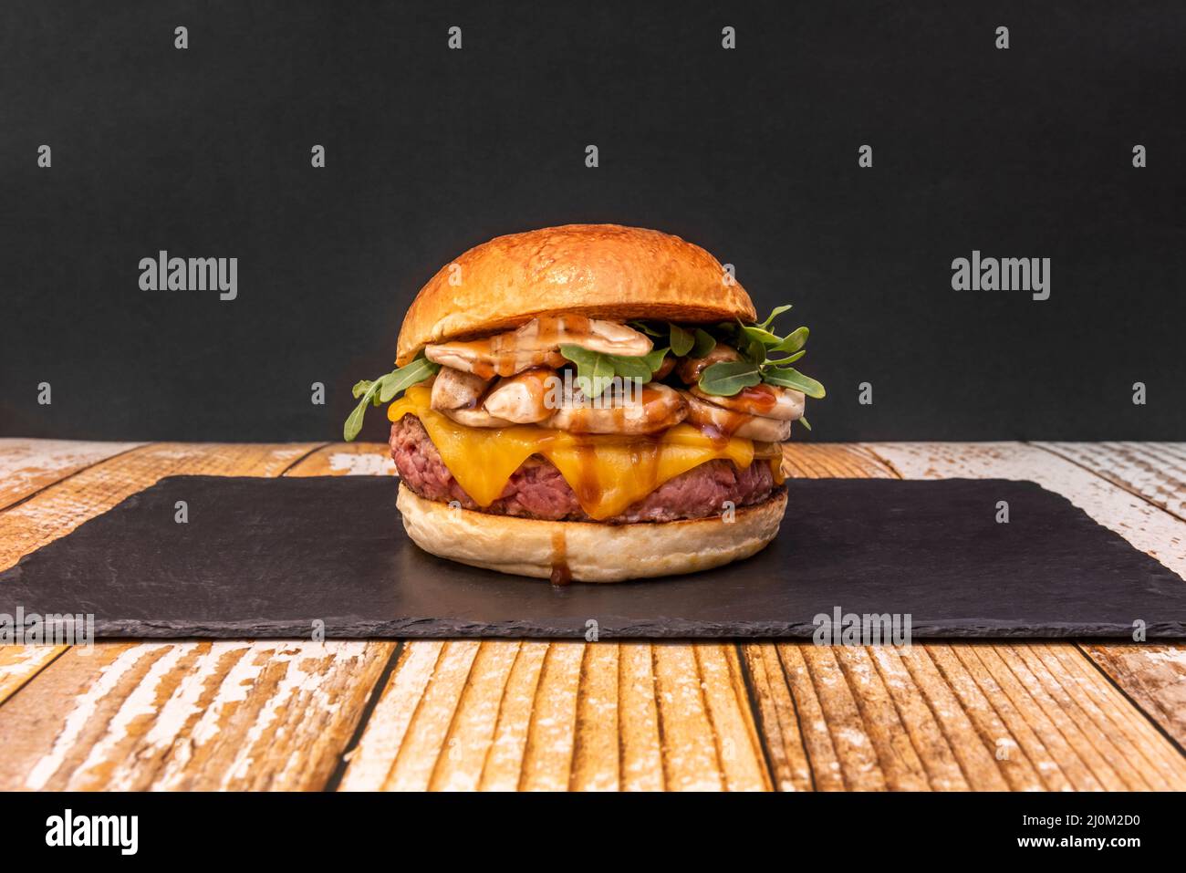 Delicious beef burger with double cheddar cheese, stewed mushrooms ...