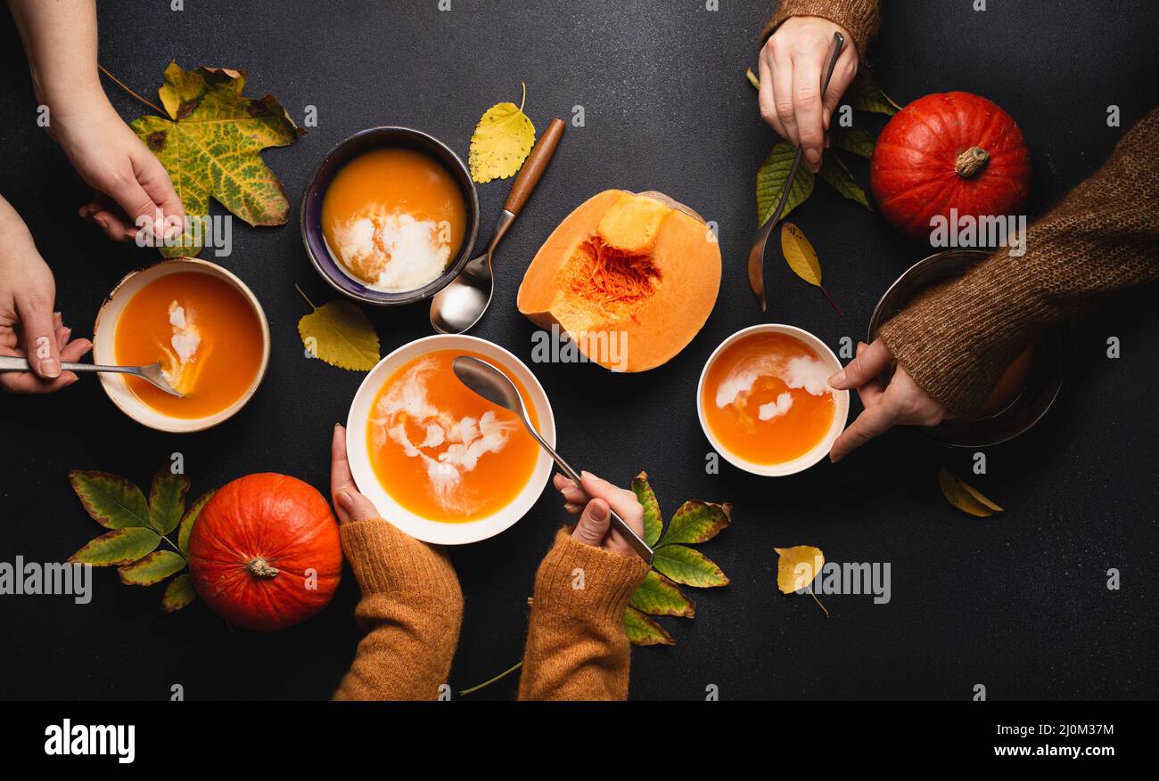 Top view people eating autumn pumpkin soup Stock Photo - Alamy