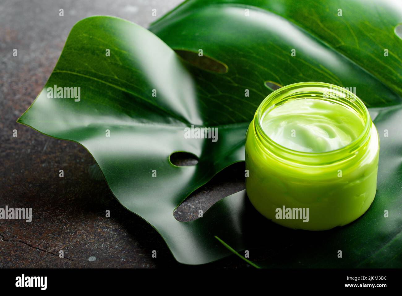 Cosmetic cream on green leaf top view Stock Photo - Alamy