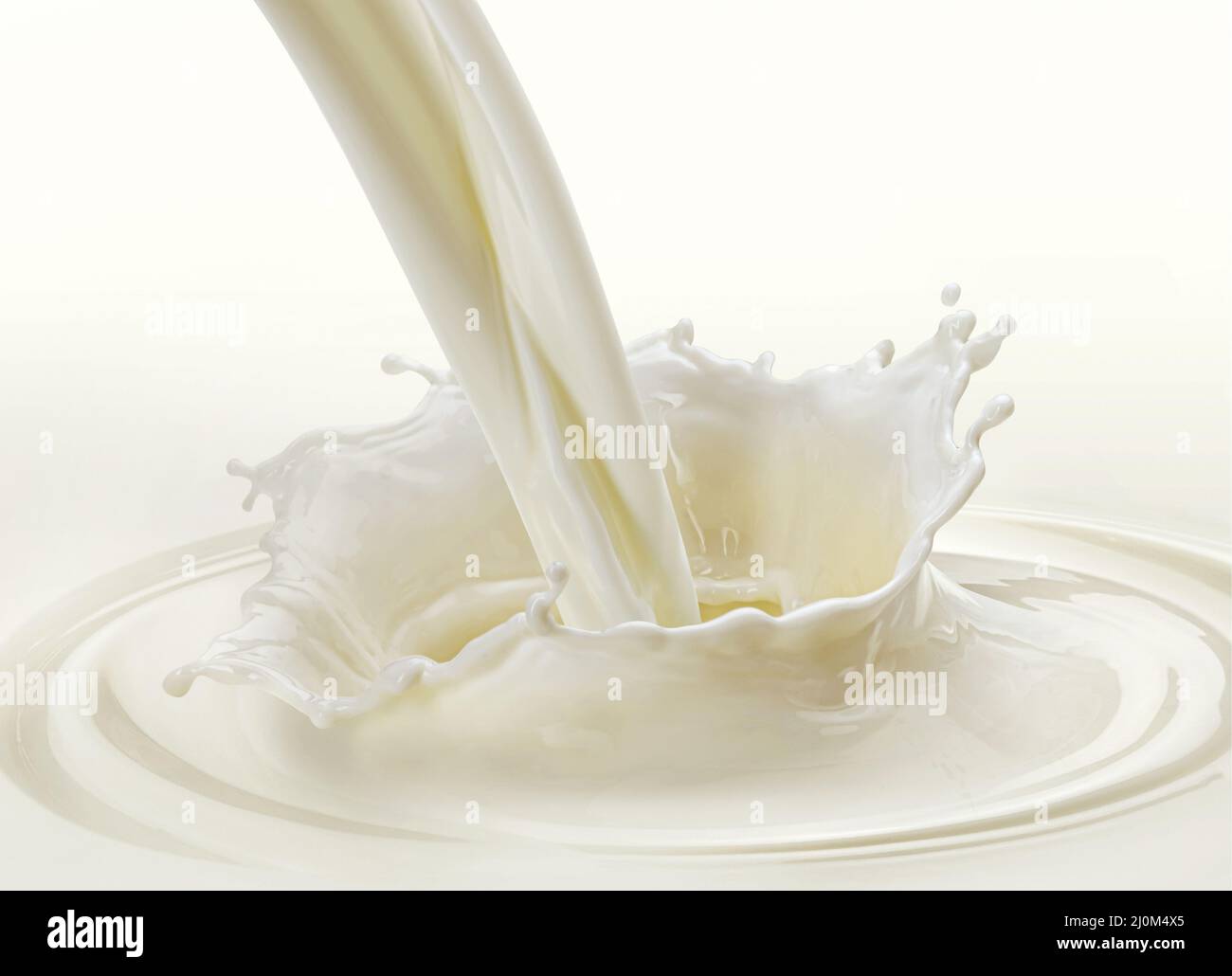 Pouring milk splash on white background Stock Photo - Alamy