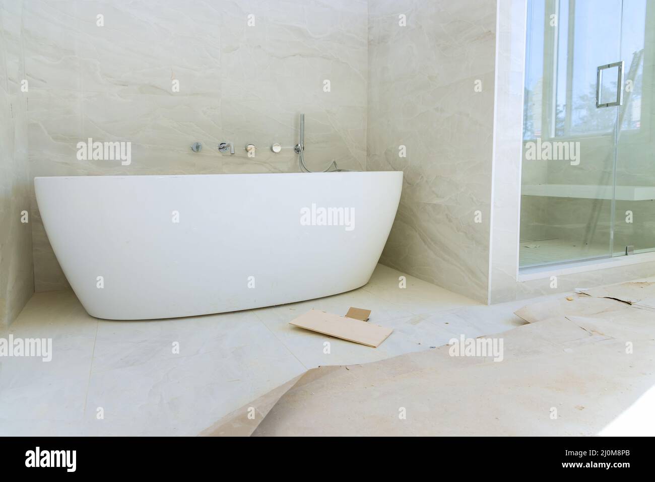 Construction work installing ceramic tile on reconstruction of bathroom ...