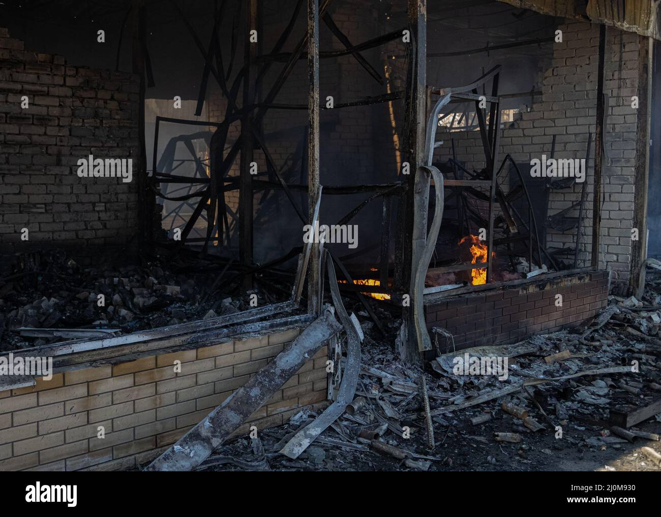 Smoke rises from the burning, charred rubble of a market in Kharkiv ...