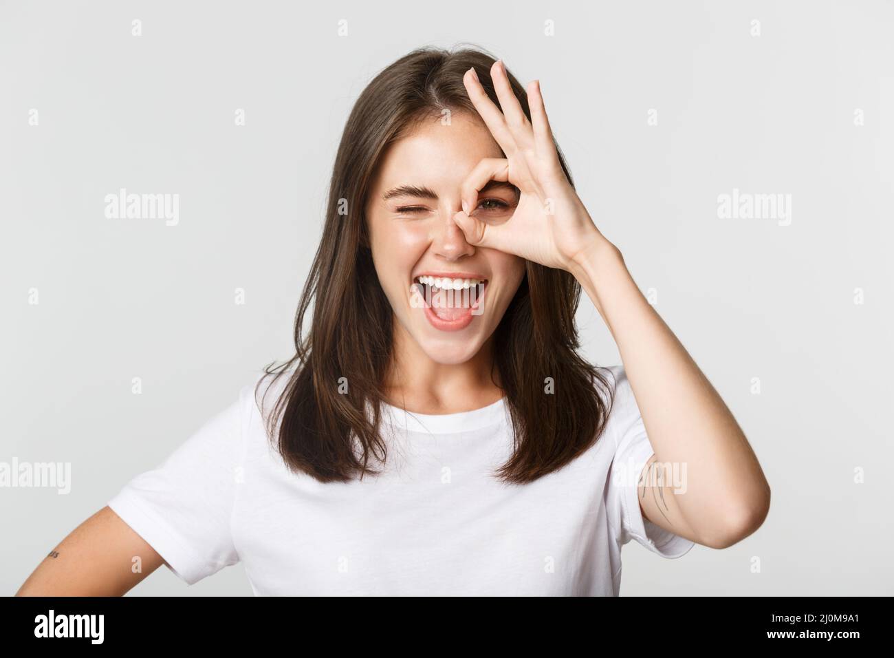Portrait cheerful girl winking showing hi-res stock photography and ...