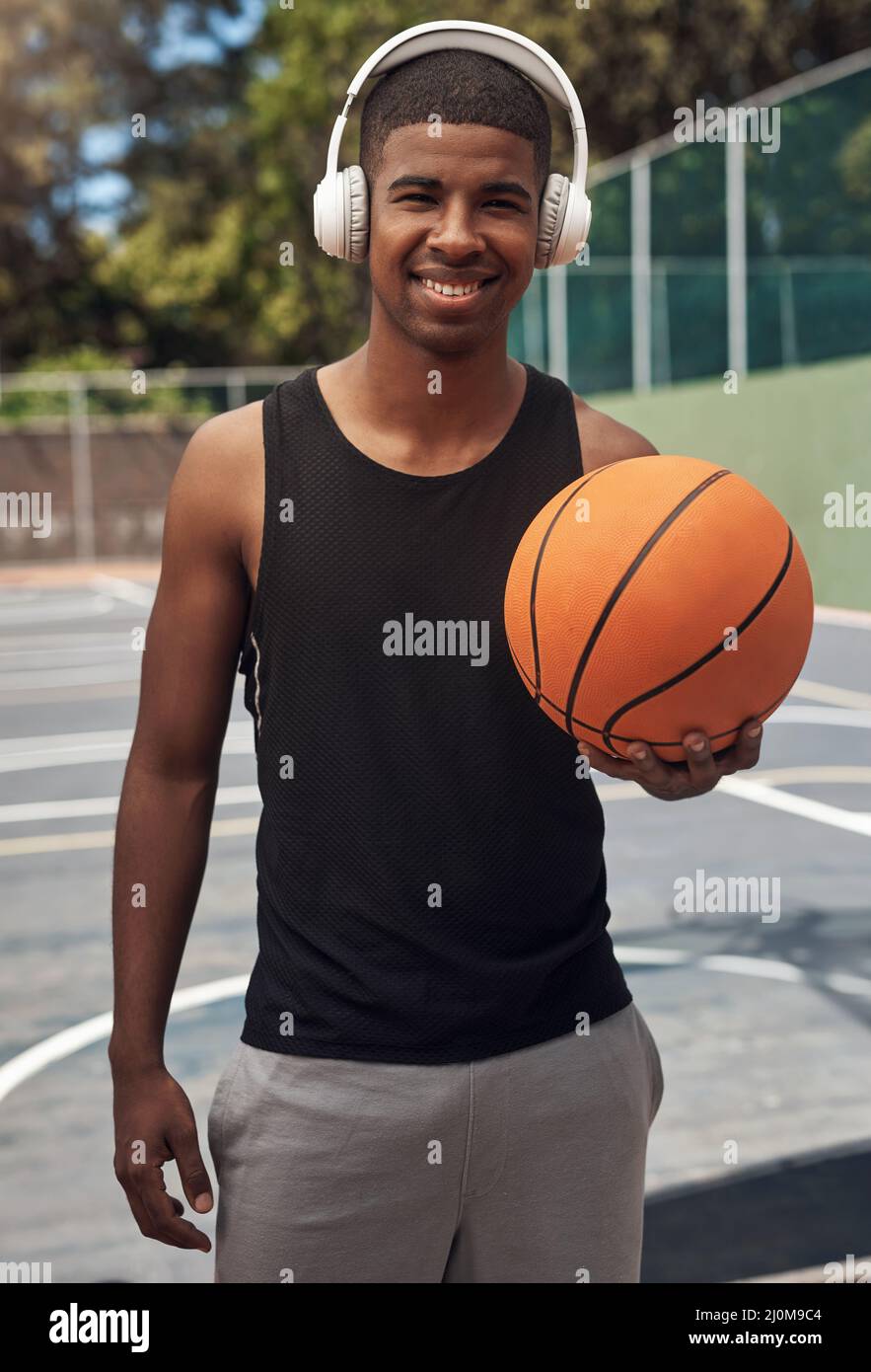 Happy young guy playing basketball hi-res stock photography and images ...