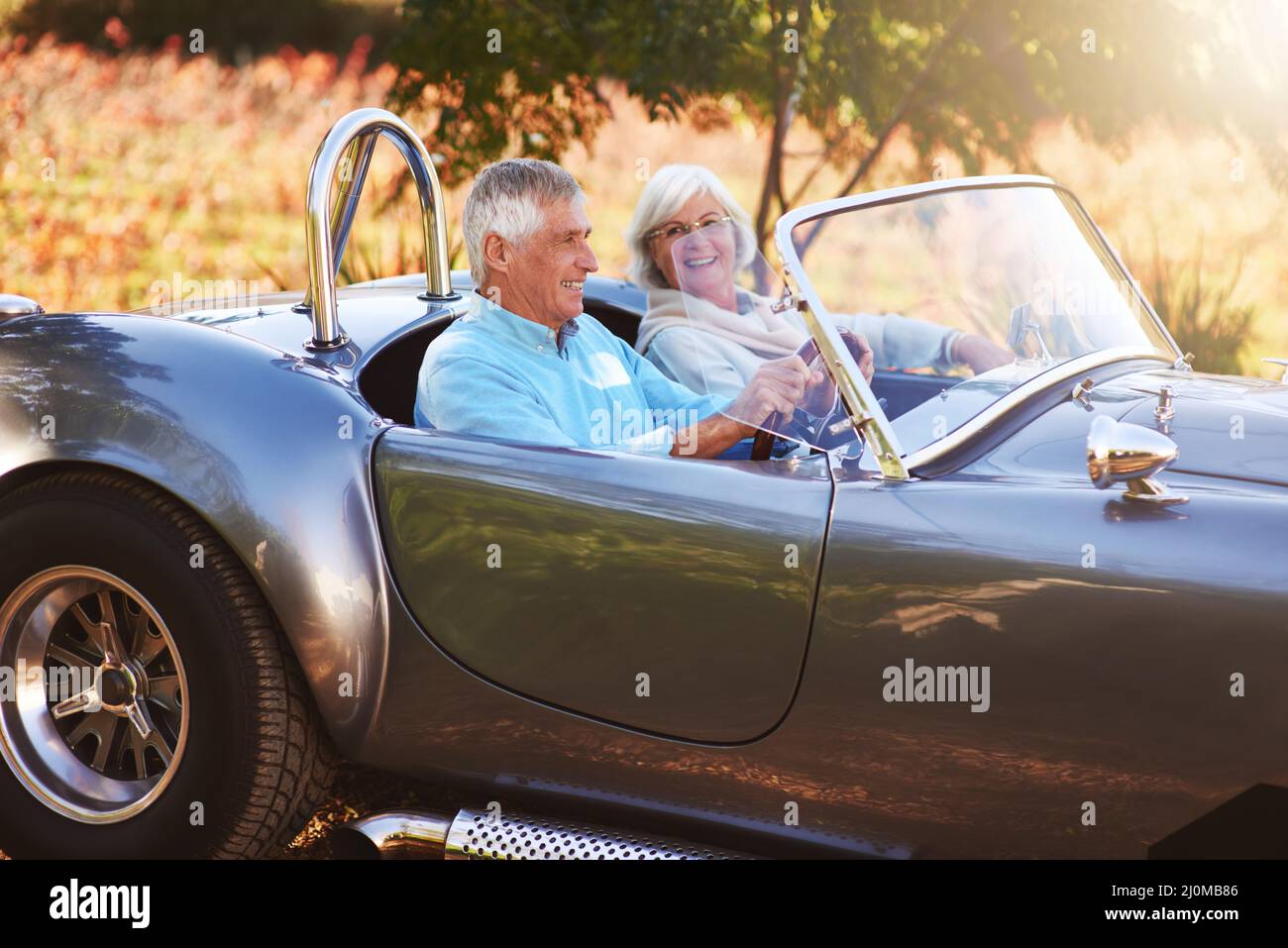Taking a drive through the countryside. Cropped shot of a senior couple ...