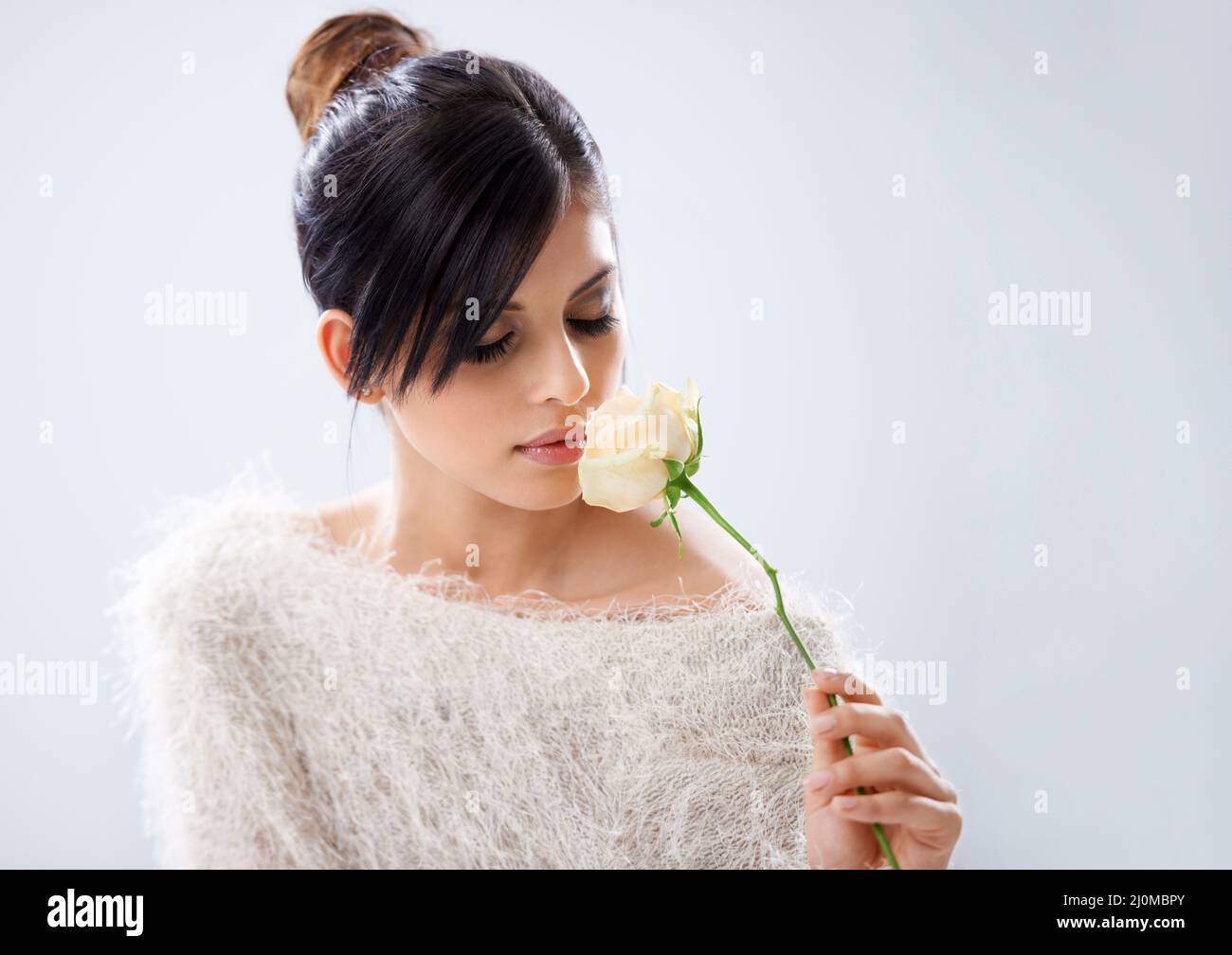 Experience natural beauty. A young woman sitting in a studio holding a ...