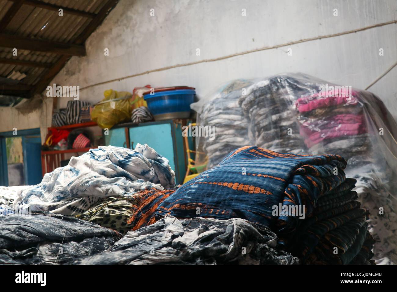 Colorful pile of batik fabrics or textiles. Colored textile in a ...