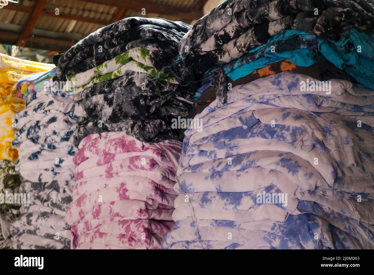 Colorful pile of batik fabrics or textiles. Colored textile in a ...
