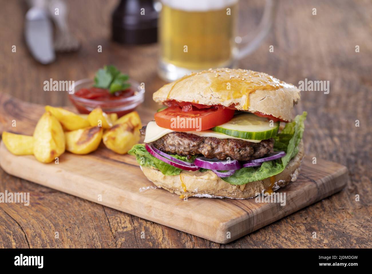Homemade burger on dark wood Stock Photo - Alamy
