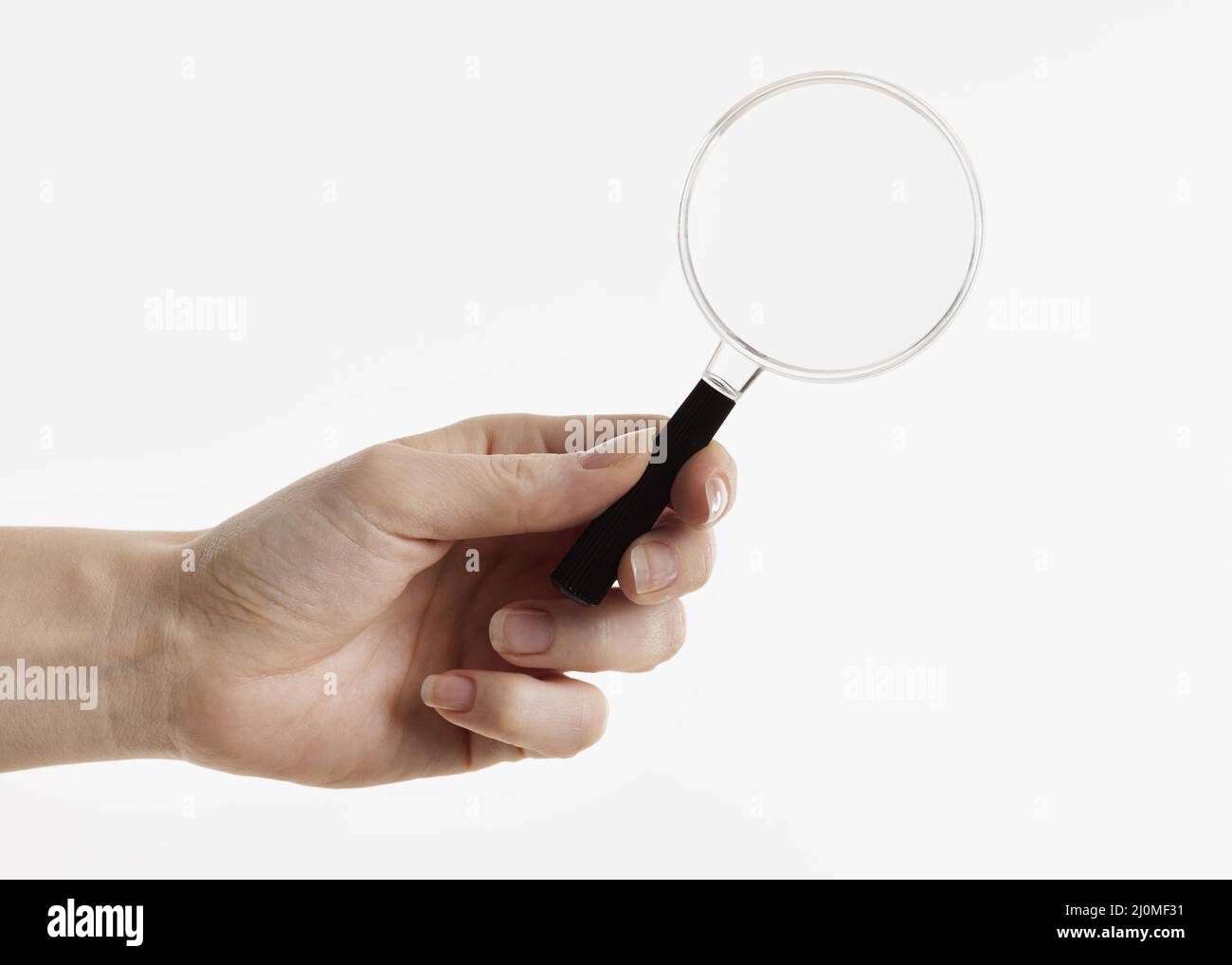 Hand holding magnifying glass Stock Photo - Alamy