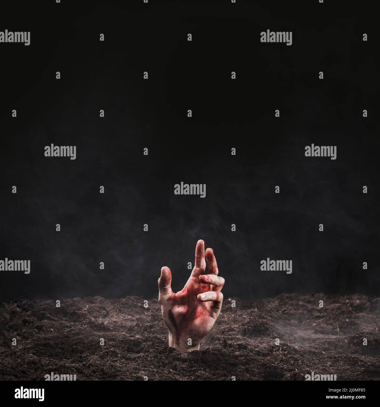 Hand protruding ground Stock Photo - Alamy