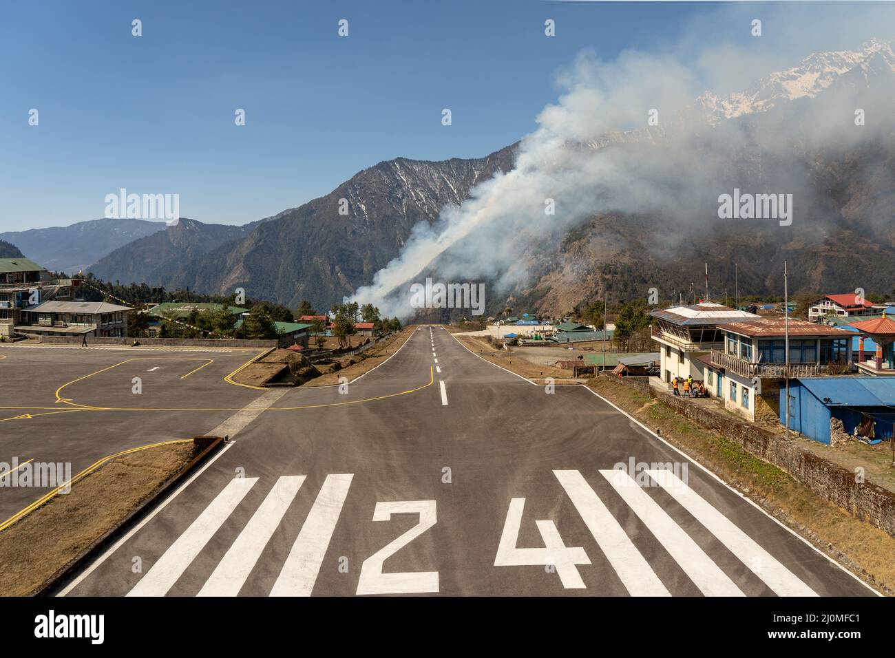 Lukla, Nepal - March 7, 2022: A fire on the mountain opposite the ...