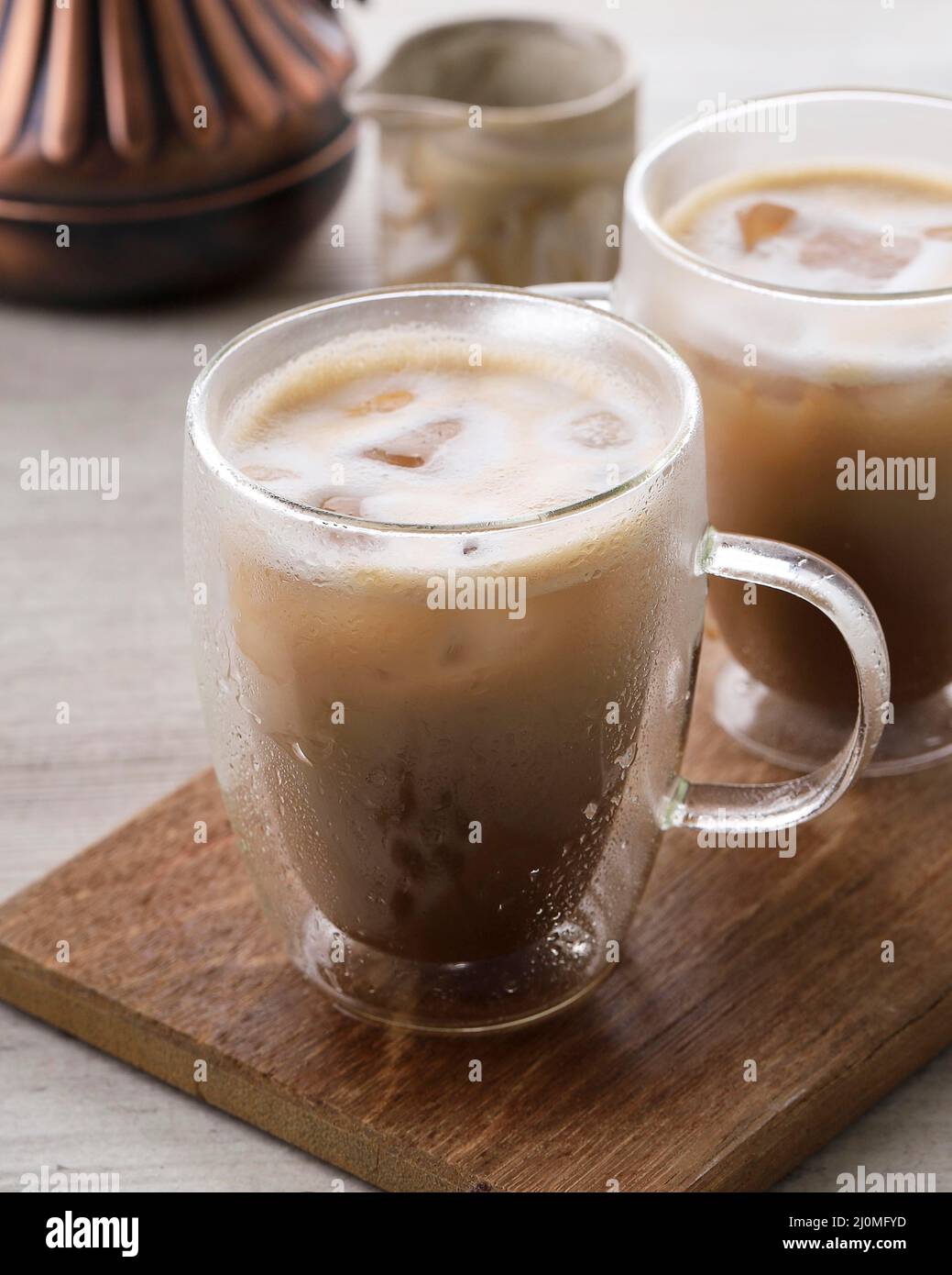 Glass of a iced coffee with cream milk. Cold brew coffee drink with ice ...