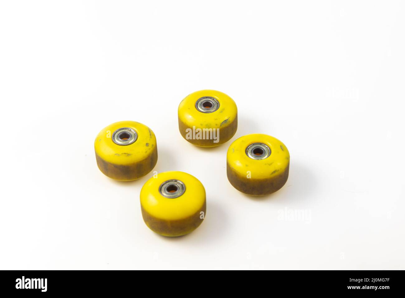 Yellow skateboard wheels on white background Stock Photo - Alamy