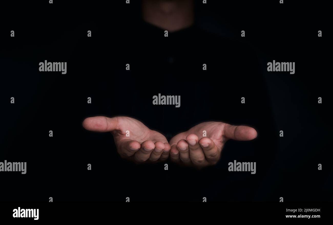 Give two hands with nothing on both on dark background with copy space ...
