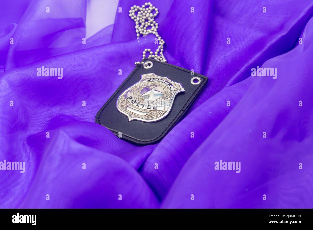 Police badge on purple background Stock Photo - Alamy