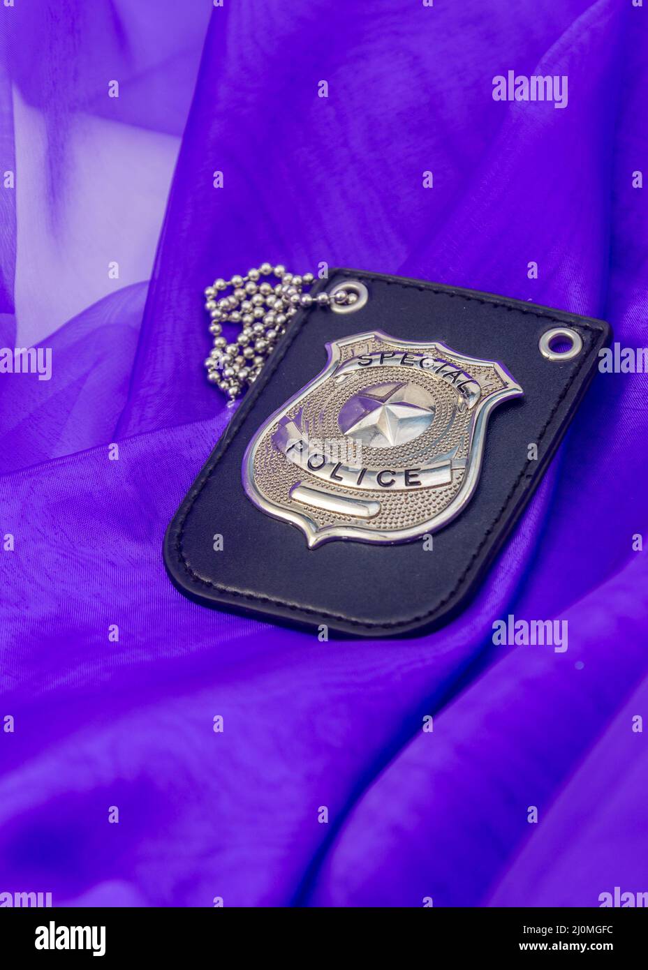 Police badge on purple background Stock Photo - Alamy
