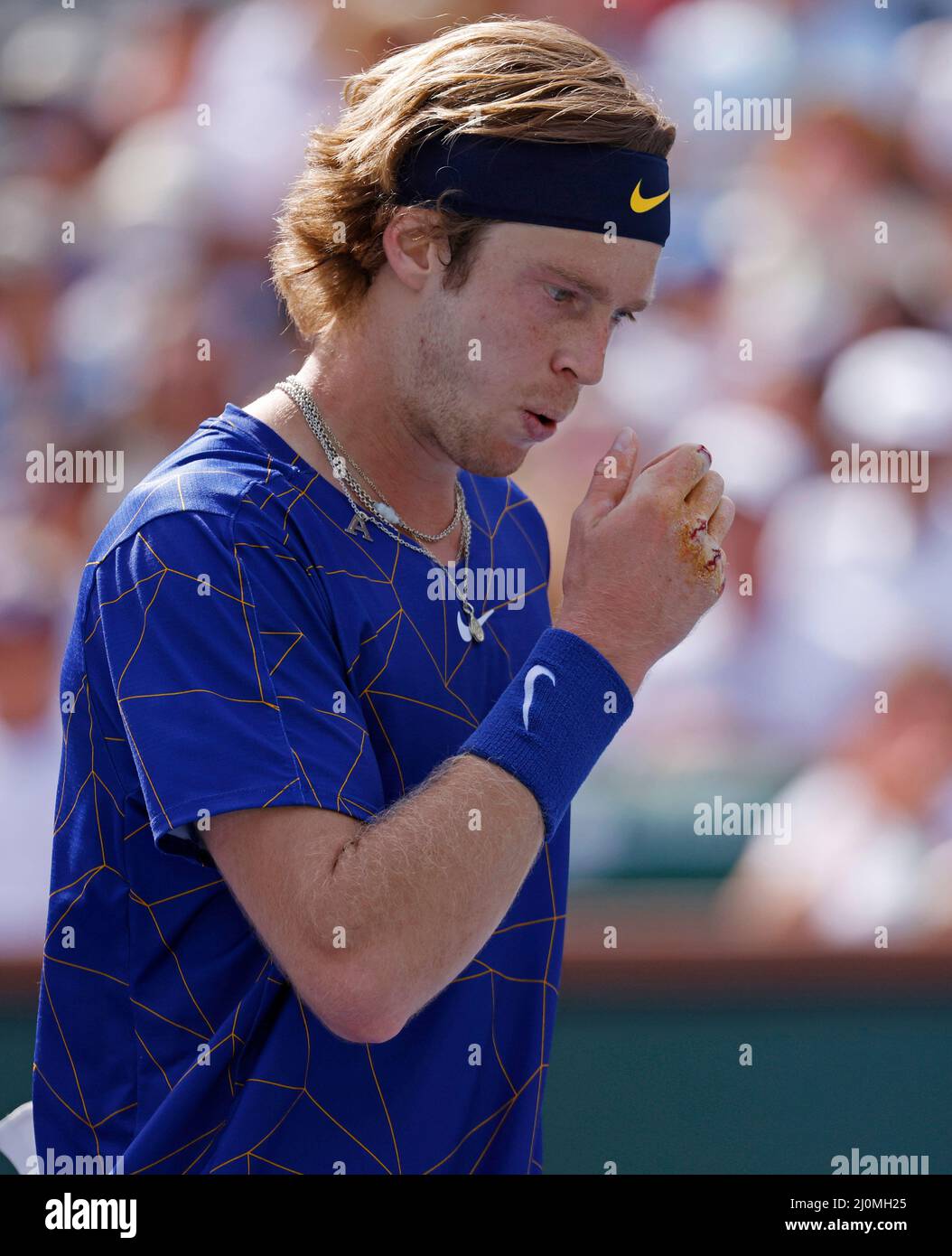 March 19, 2022 Andrey Rublev of Russia blows on his hand after hitting ...