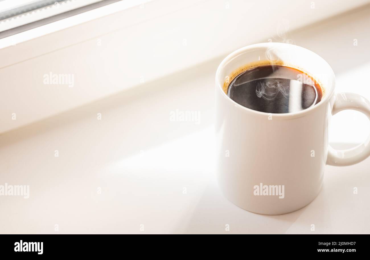 Cup of coffee on the window sill Stock Photo - Alamy