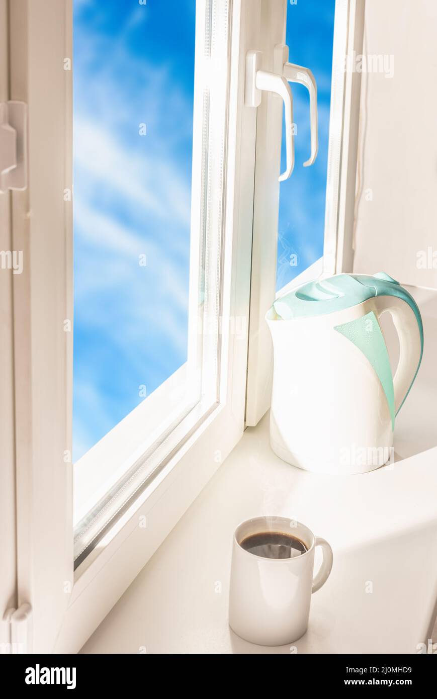 Cup of coffee on the window sill Stock Photo - Alamy