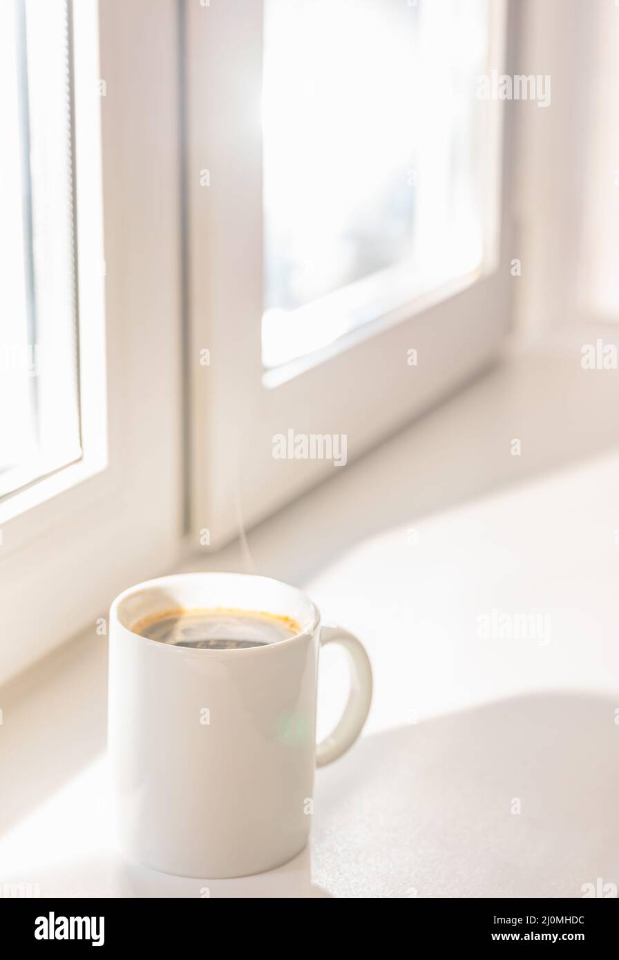 Cup of coffee on the window sill Stock Photo - Alamy