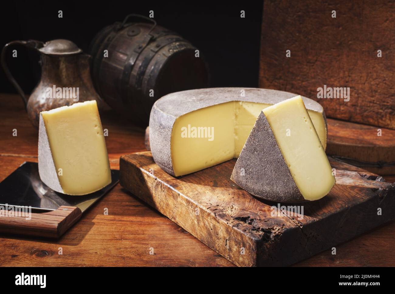 Traditional aged mountain cheese of the Alps offered as loaf and piece ...