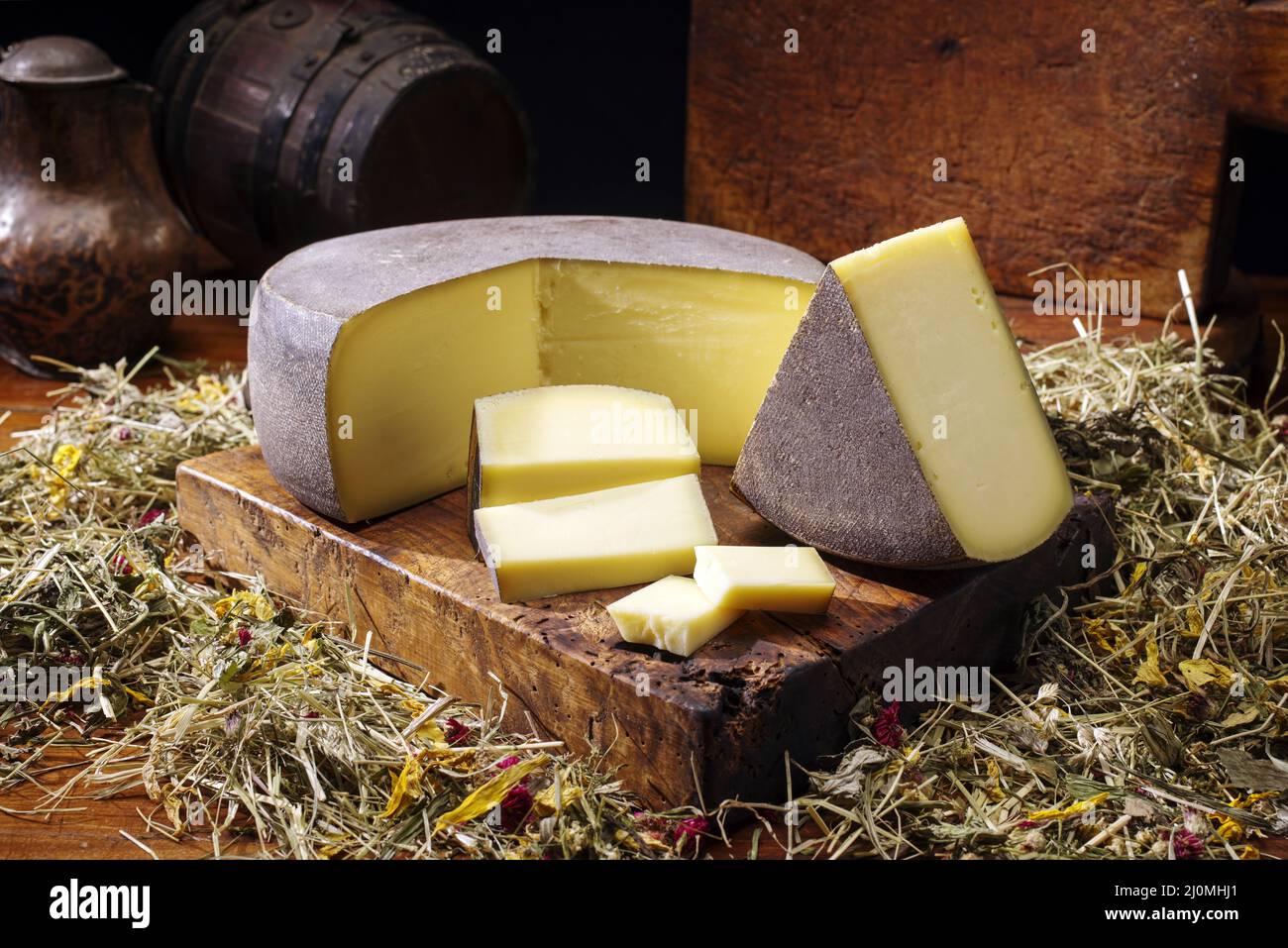 Traditional aged mountain cheese of the Alps offered as loaf and piece ...