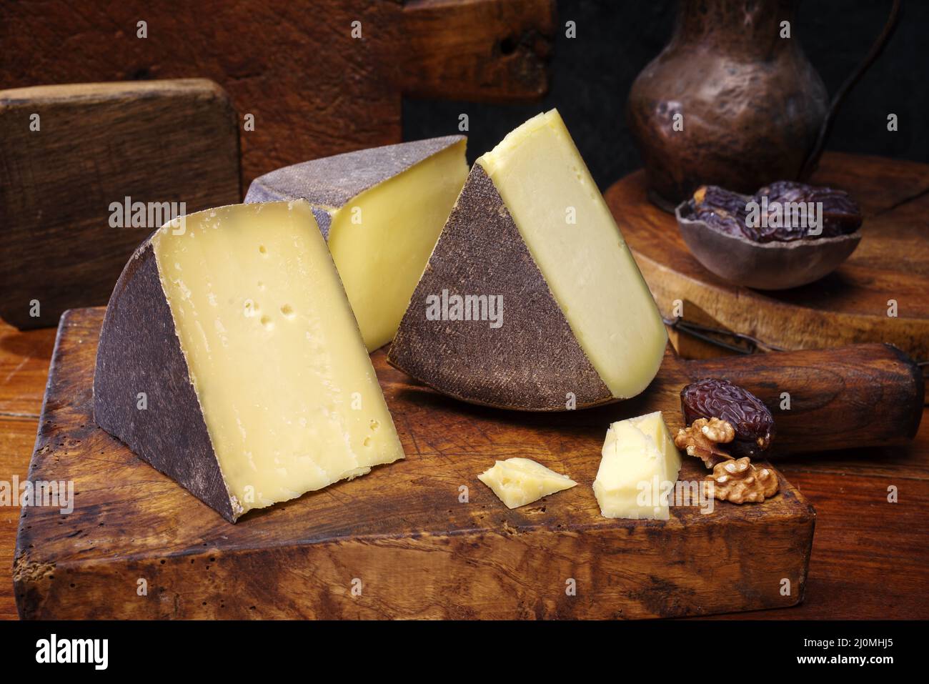 Traditional aged mountain cheese of the Alps offered with dates and ...
