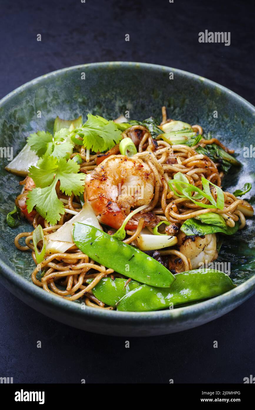 Modern style traditional stir-fried Thai phak kung with king prawns ...