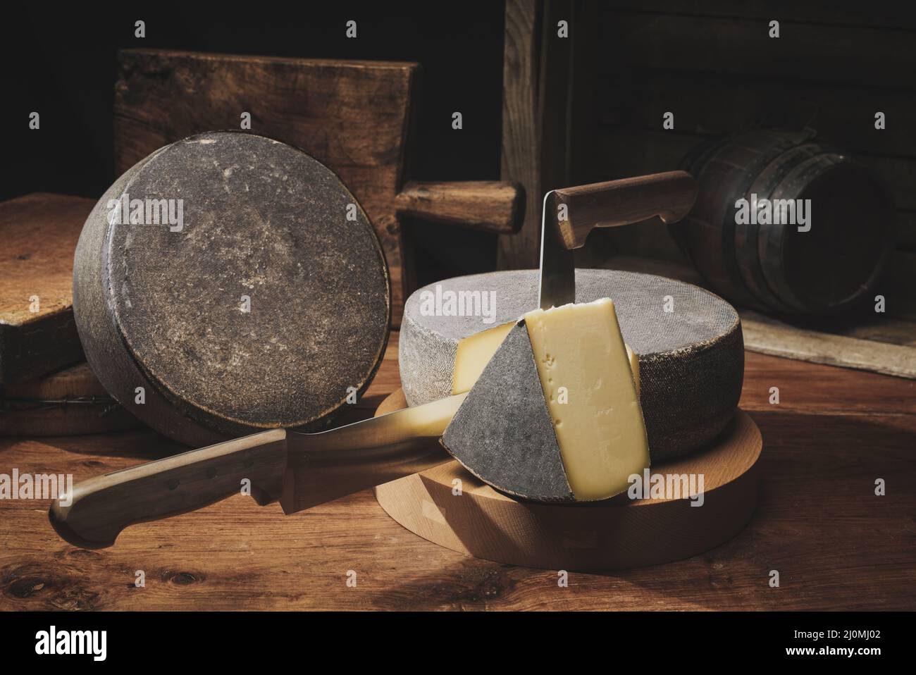 Traditional aged mountain cheese of the Alps offered as loaf and piece ...