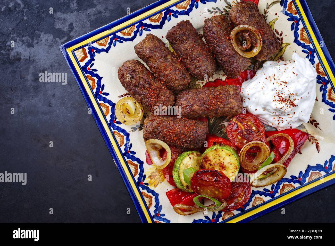 Traditional Croatian cevapi spicy meat ball rolls with BBQ vegetable ...