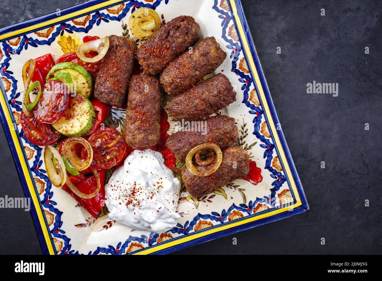 Traditional Croatian cevapi spicy meat ball rolls with BBQ vegetable ...
