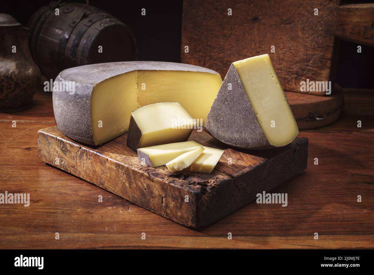 Traditional aged mountain cheese of the Alps offered as loaf and piece ...