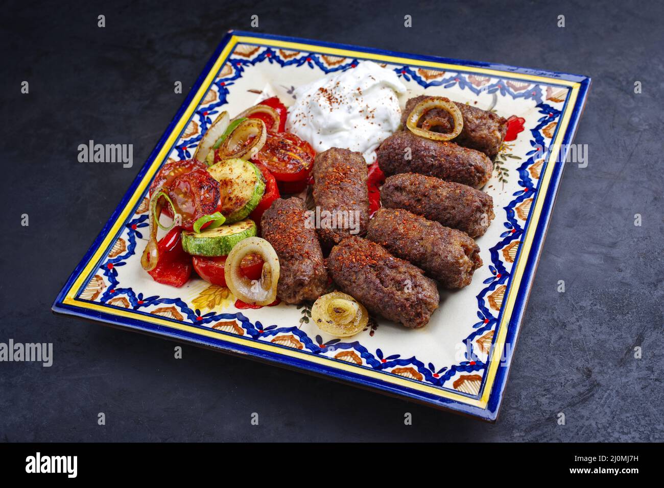 Traditional Croatian cevapi spicy meat ball rolls with BBQ vegetable ...