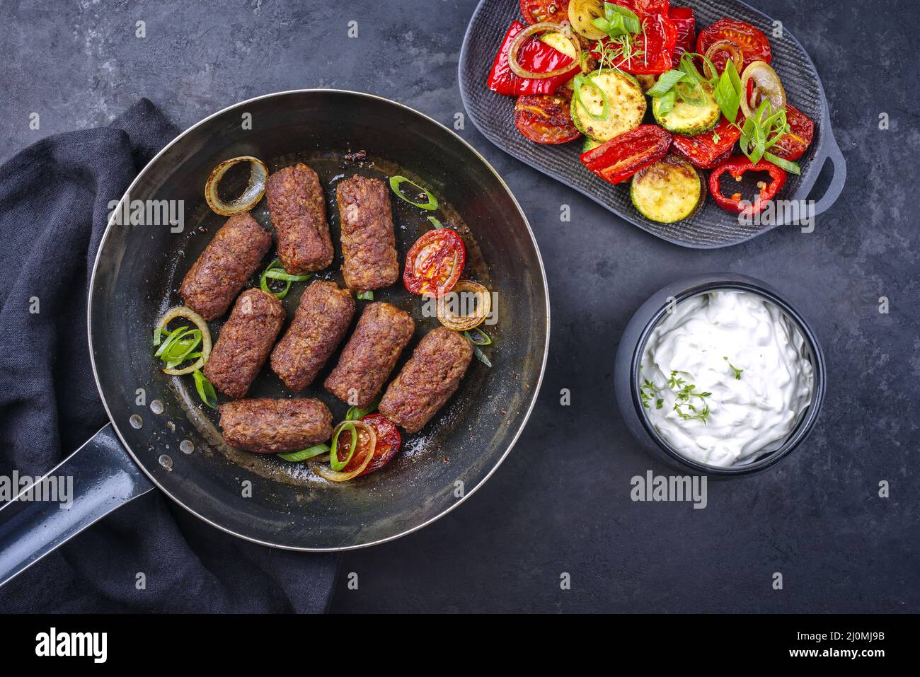 Traditional Croatian cevapi spicy meat ball rolls with BBQ vegetable ...