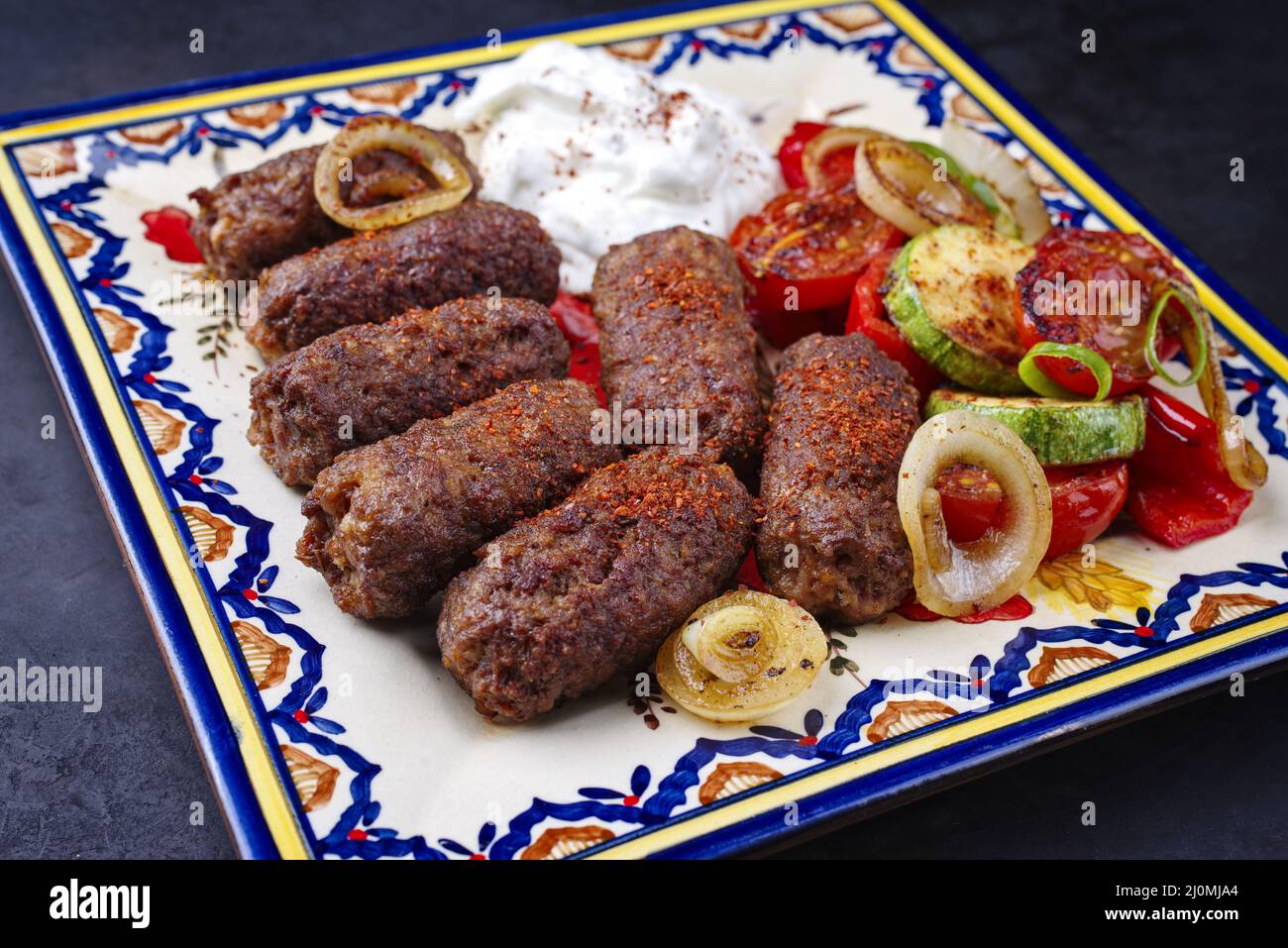 Traditional Croatian cevapi spicy meat ball rolls with BBQ vegetable ...