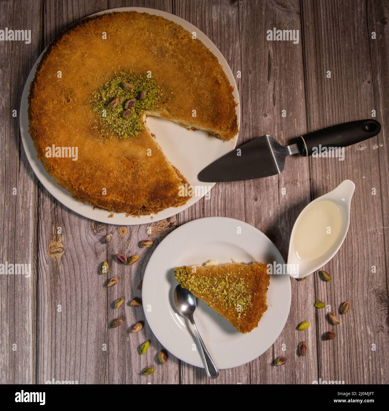 Delicious Traditional Dessert Knafeh with cheese and pistachios and ...