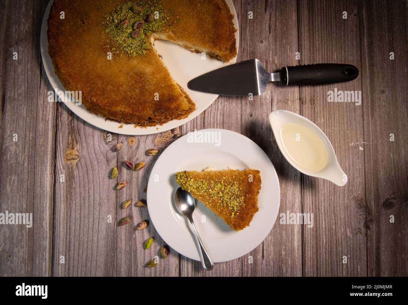 Delicious Traditional Dessert Knafeh with cheese and pistachios and ...