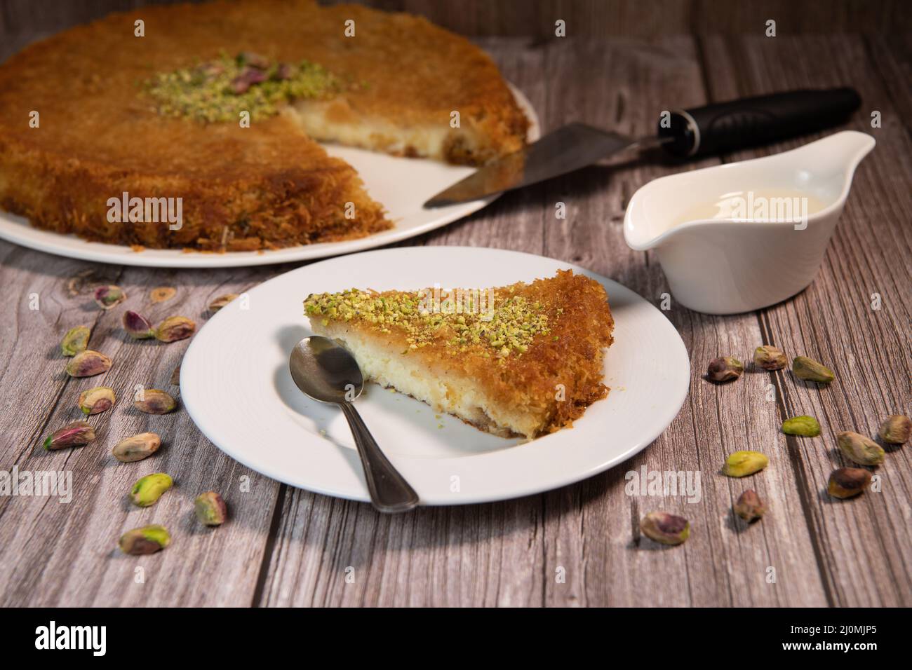 Delicious Traditional Dessert Knafeh with cheese and pistachios and ...