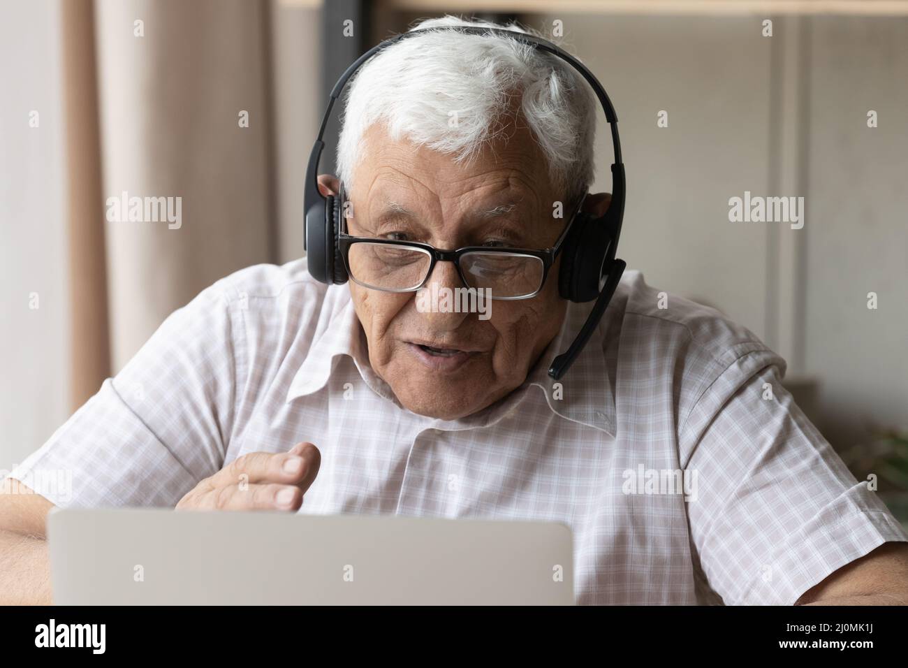 Older man wear headset lead distance conversation use videocall app ...