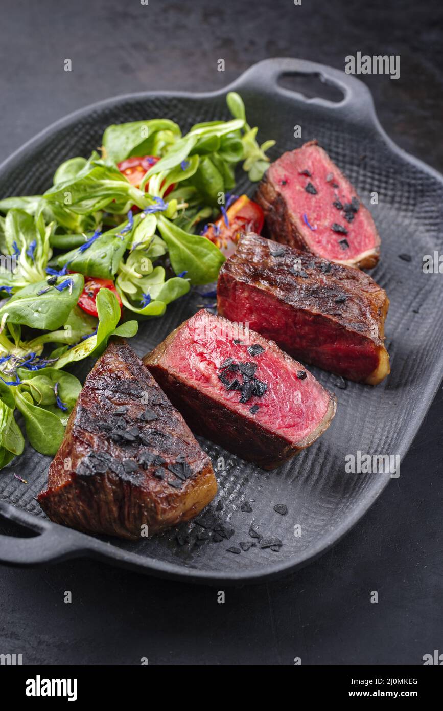 Rustic style barbecue dry aged wagyu roast beef steak with lambs ...