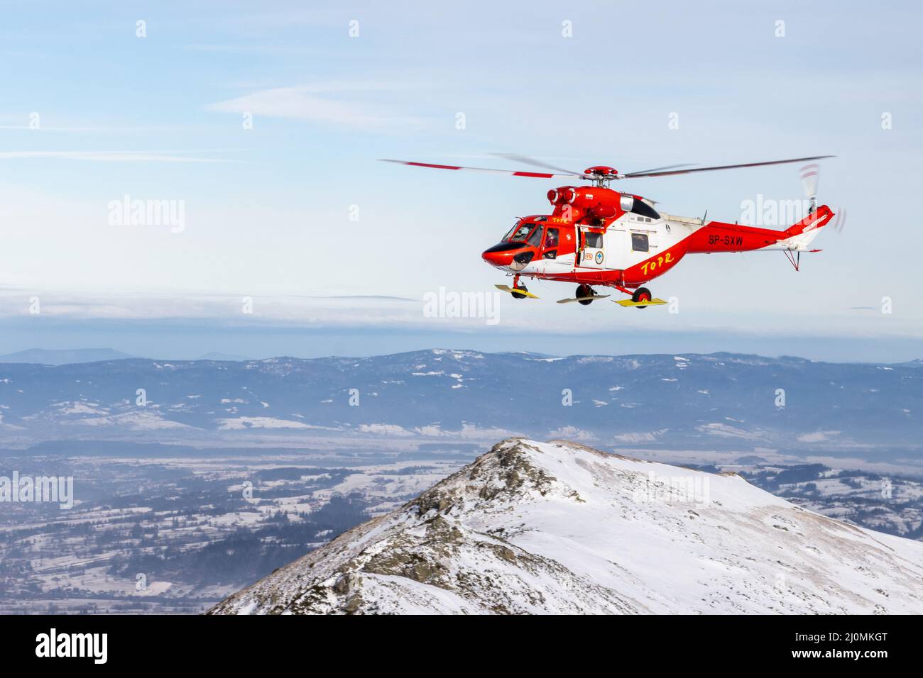 Tatra Mountains. Red and white rescue helicopter, flying over Kasprowy ...