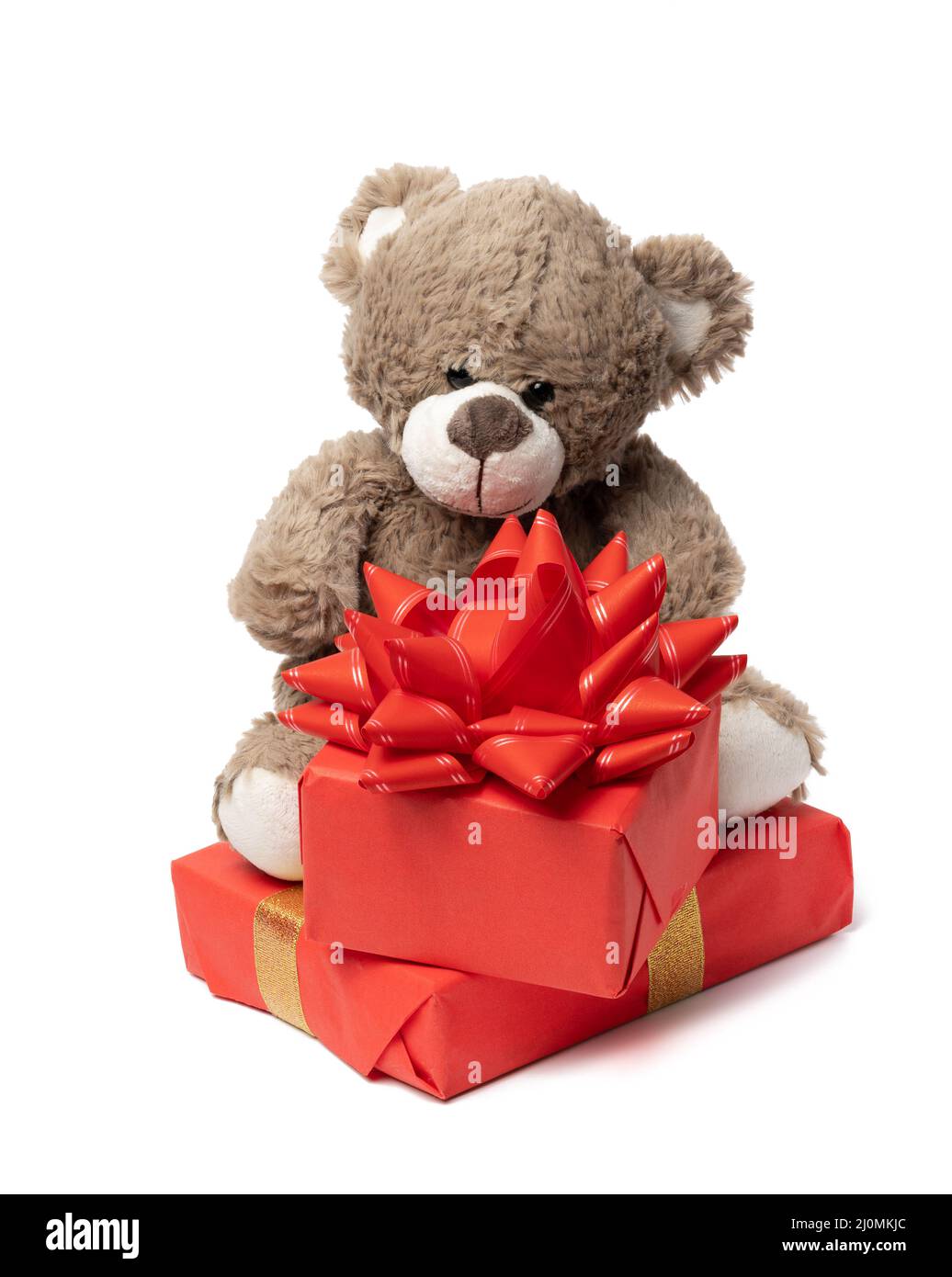 Cute brown teddy bear and box wrapped in paper and red silk ribbon on ...