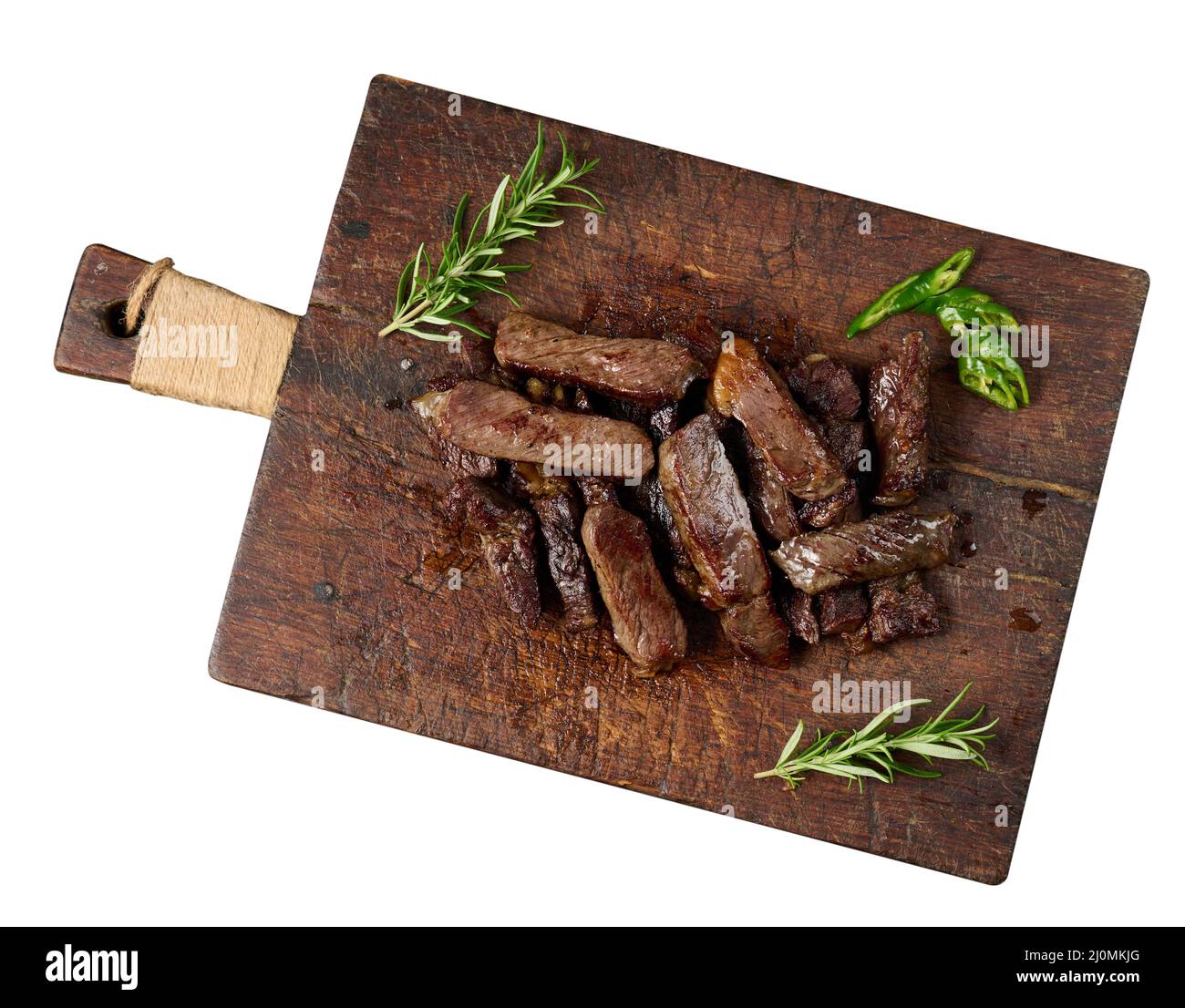 Roasted piece of beef ribeye cut into pieces on a vintage brown ...