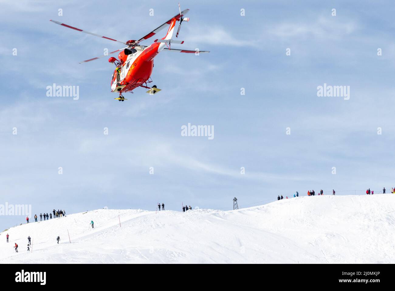 Tatra Mountains. Red and white rescue helicopter, flying over Kasprowy ...