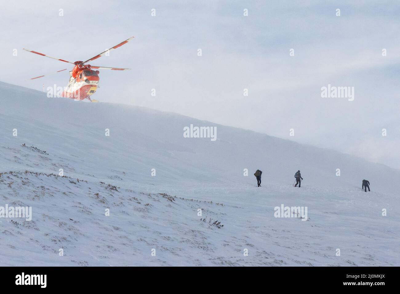 Tatra Mountains. Red and white rescue helicopter, flying over Kasprowy ...