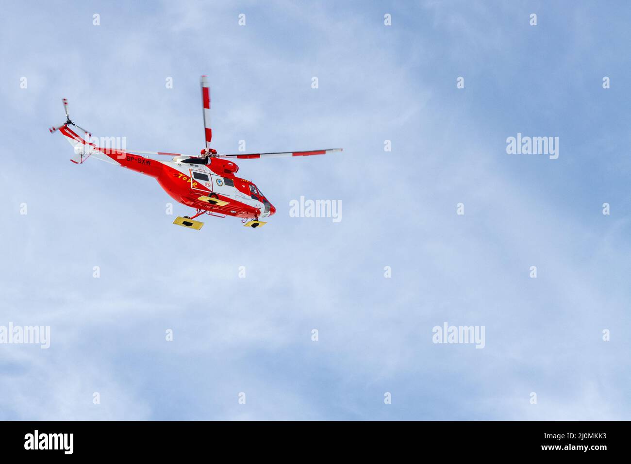 Tatra Mountains. Red and white rescue helicopter, flying over Kasprowy ...