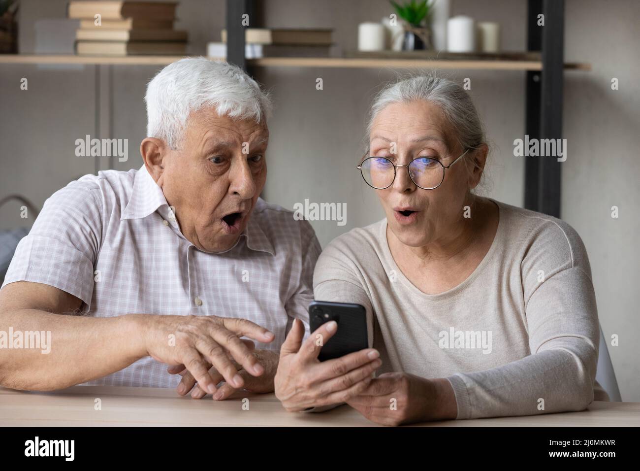 Grandparents open mouth gawp at cellphone screen, read unbelievable ...